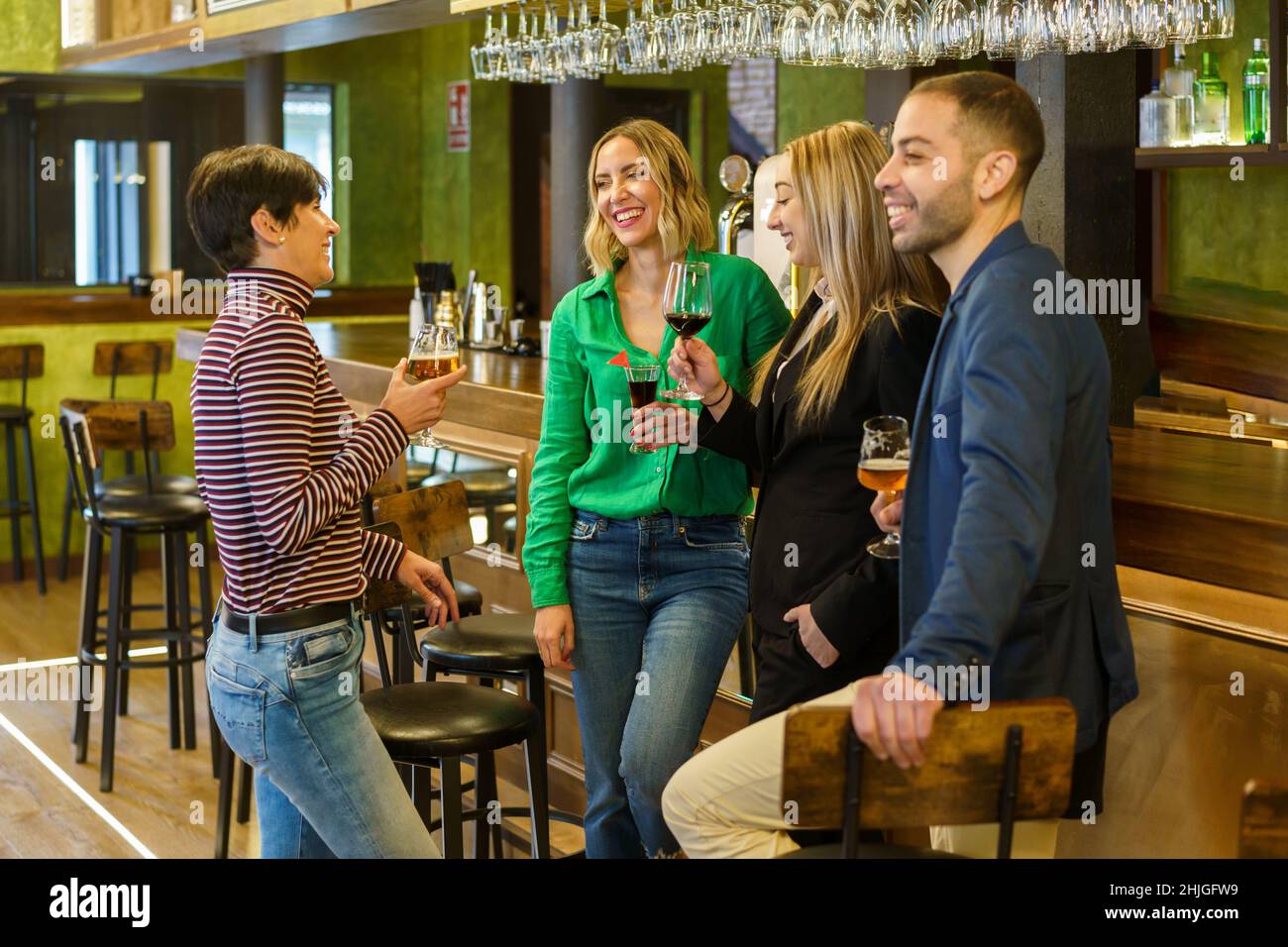 Happy friends chatting in a beautiful bar Stock Photo - Alamy