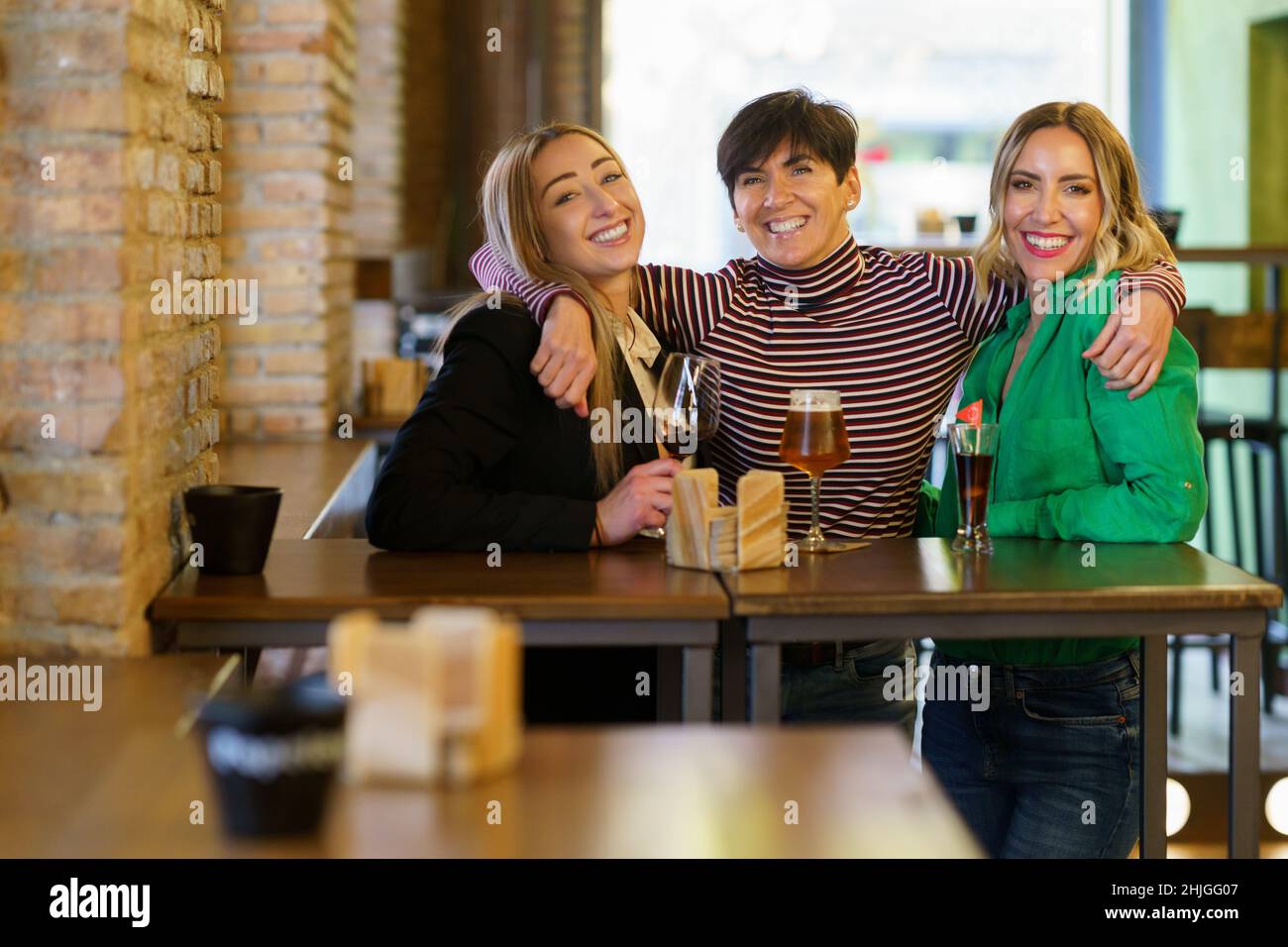 Happy women hugging during party in bar Stock Photo - Alamy