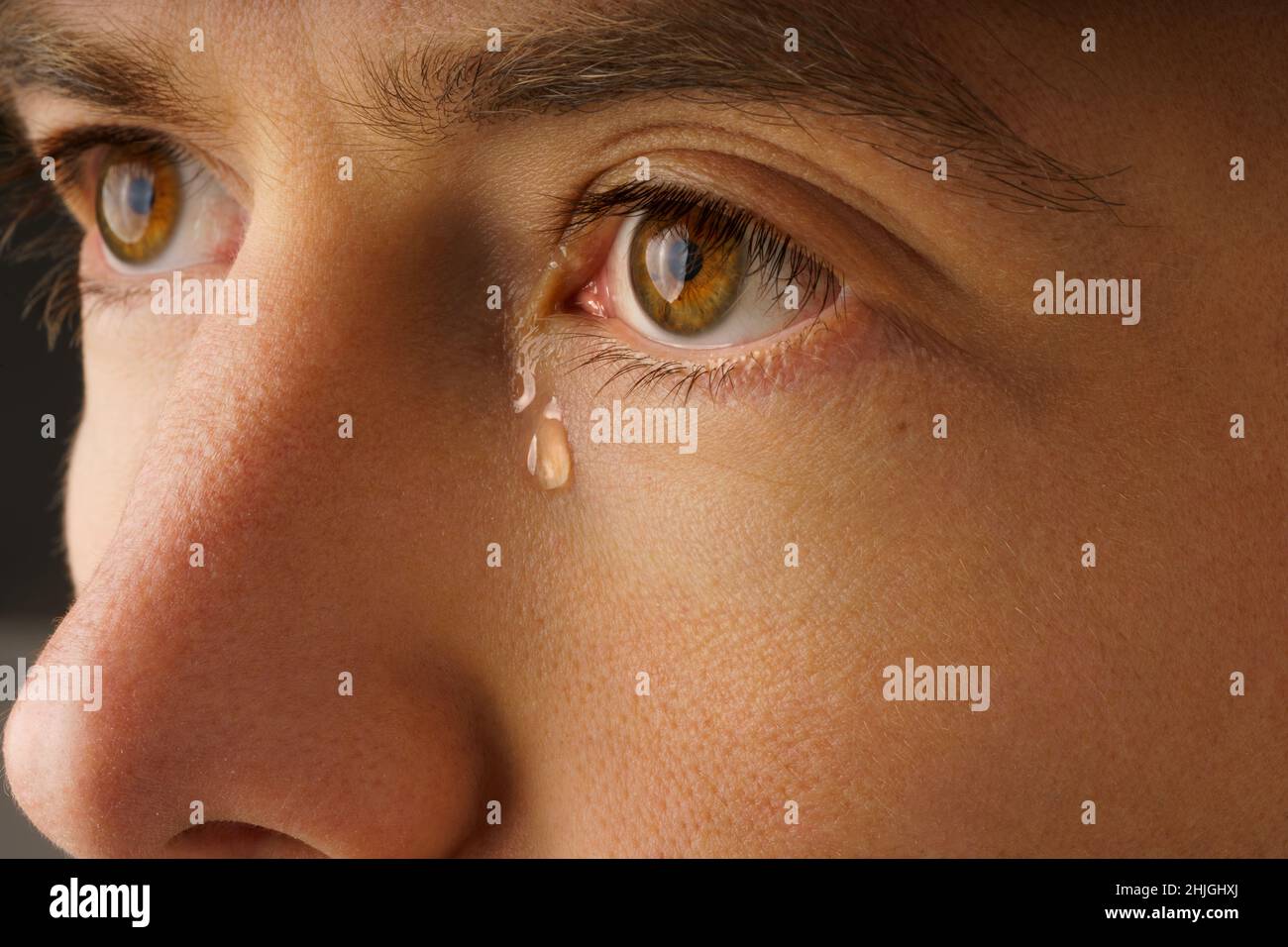Closeup photo of young man eye with a tear. Man crying Stock Photo - Alamy