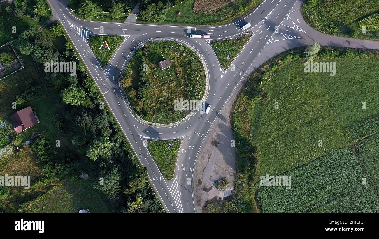 Roundabout traffic of cars and trucks on the circle ring road aerial ...