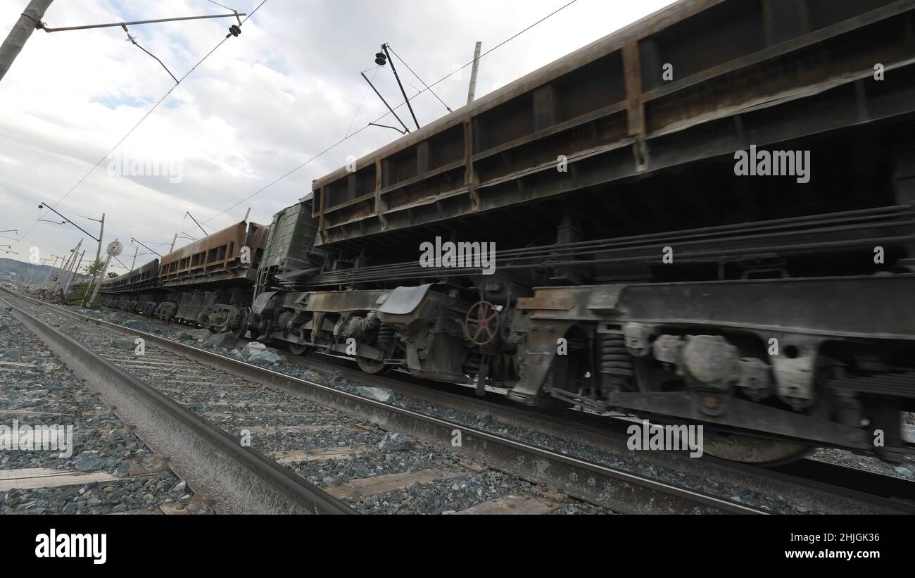 Moving of diesel locomotive and railway cars filled with ore. Quarry ...