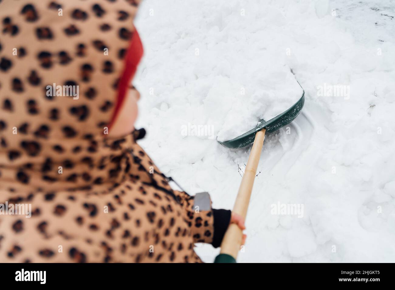 Low angle view of the little kid girl helping to clean pathway from ...
