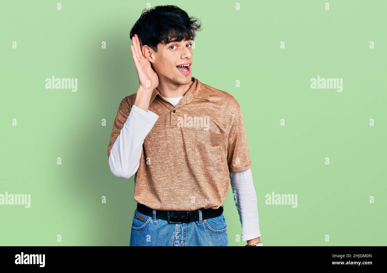 Handsome hipster young man wearing 90s retro style smiling with hand ...