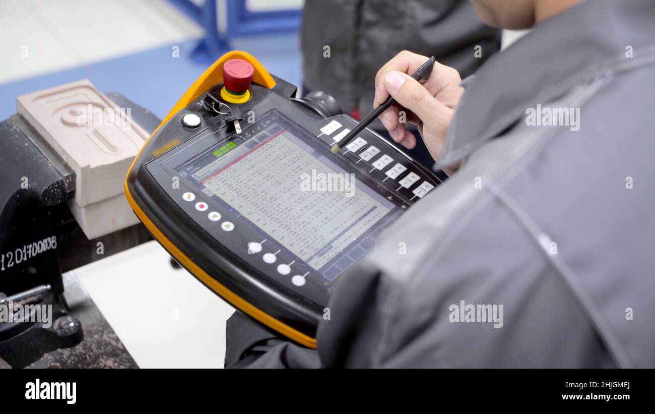 Worker uses touch control panel. Scene. Skilled worker uses electronic ...