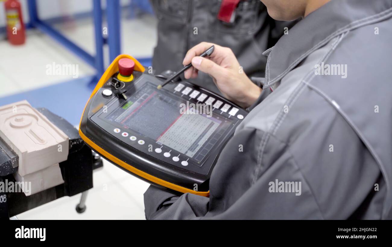 Worker uses touch control panel. Scene. Skilled worker uses electronic ...