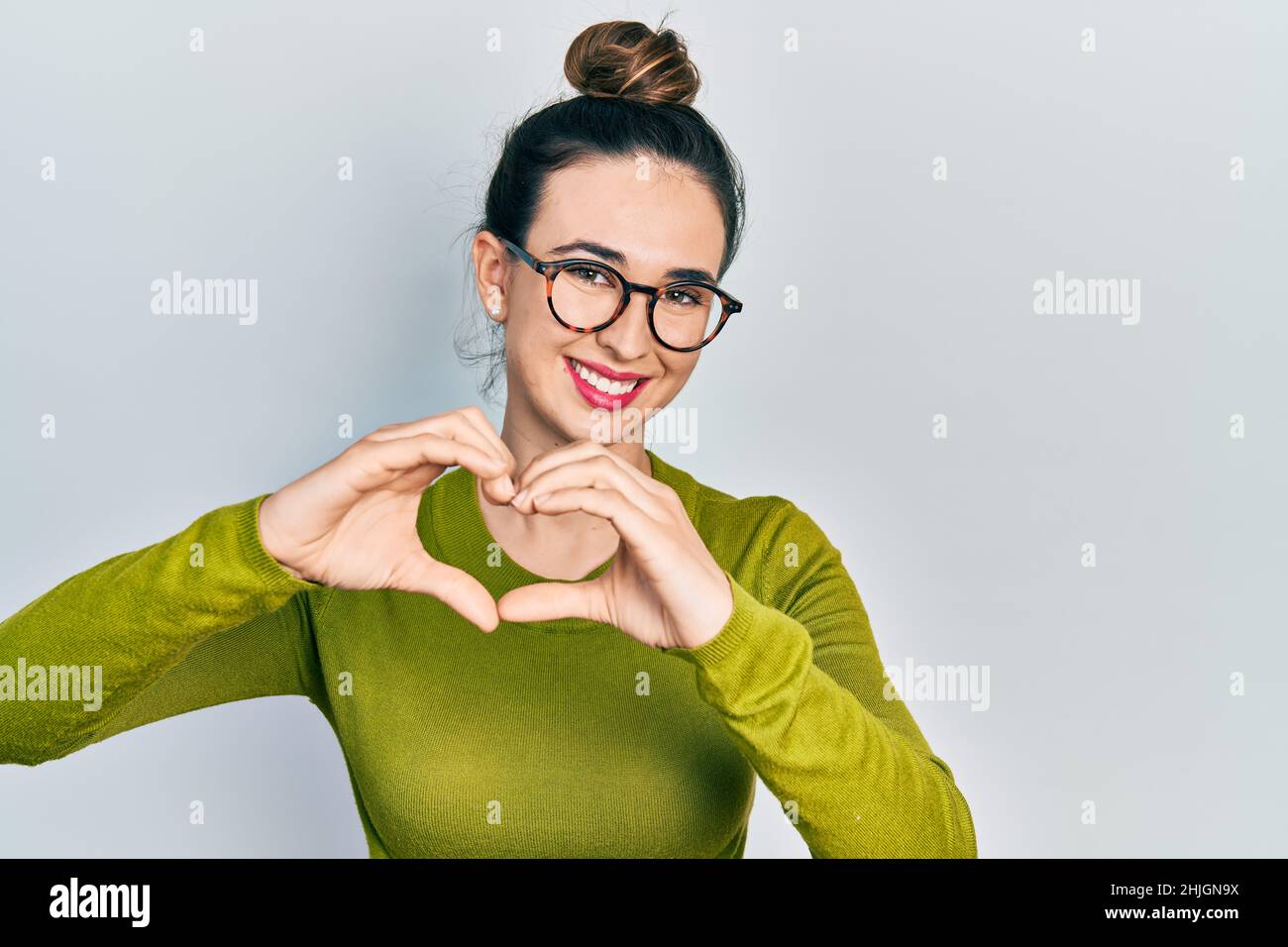 Young Hispanic Girl Wearing Casual Clothes And Glasses Smiling In Love