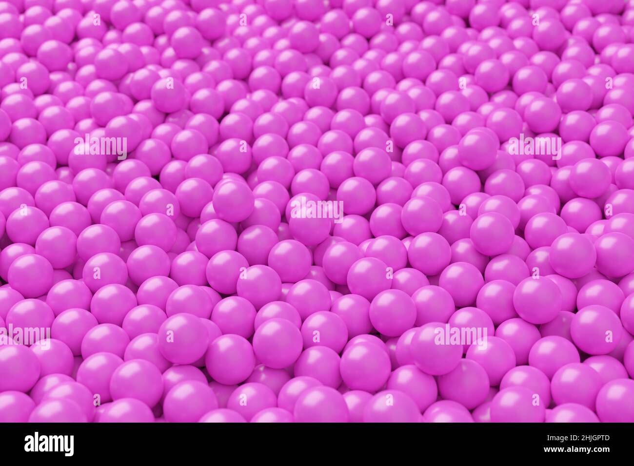 Ball pool or pit filled with pink plastic balls, abstract texture ...