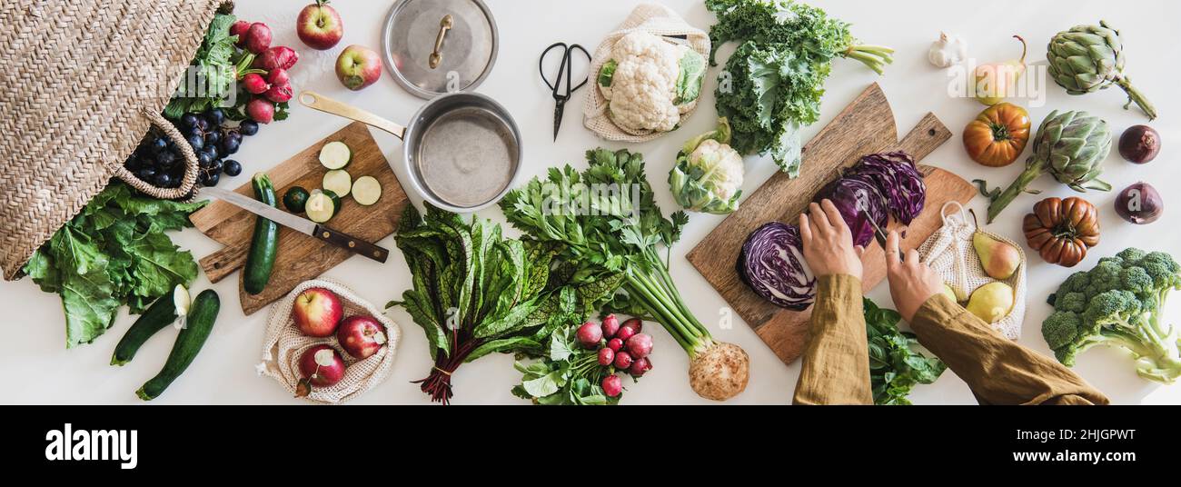 Fall vegetarian cooking background. Female hands cutting cabbage on ...