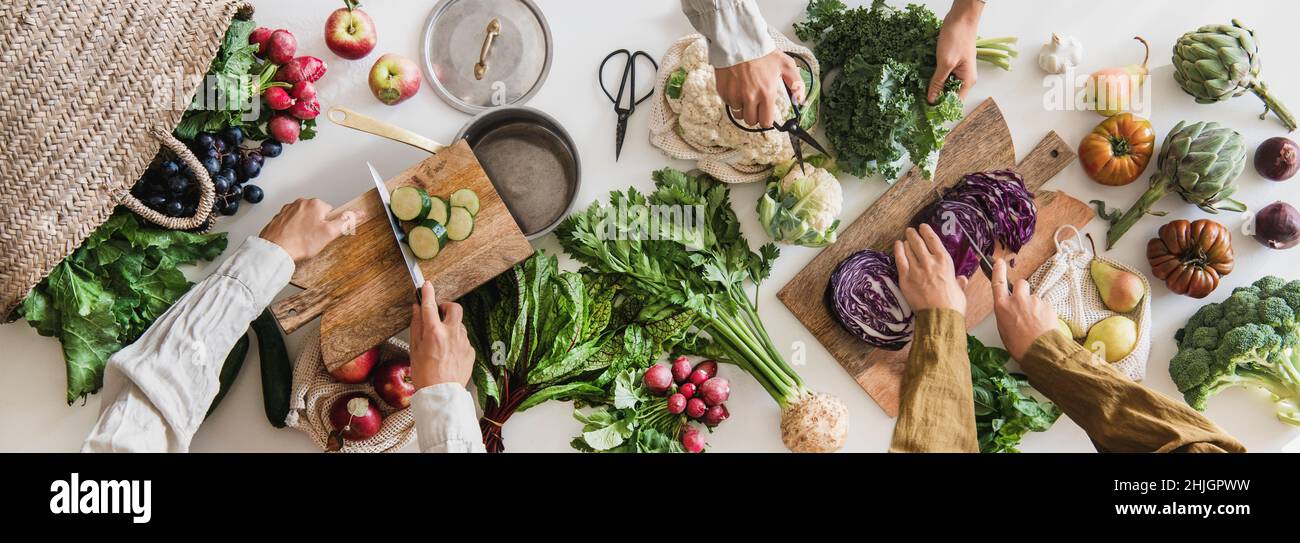 Fall vegetarian cooking background. Female hands cutting greens and ...