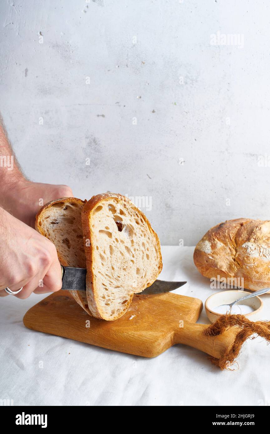 Male hands cutting loaf hi-res stock photography and images - Alamy