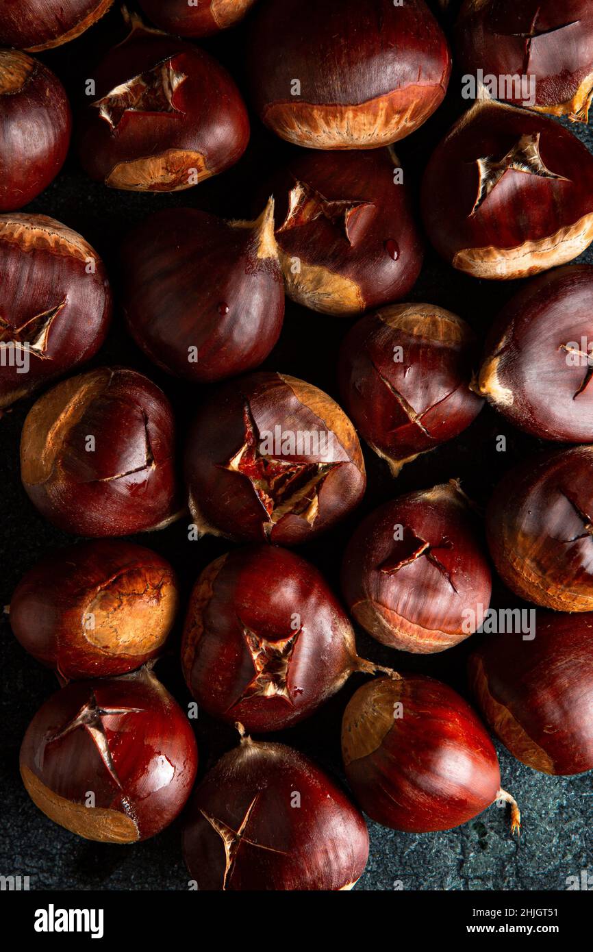 Fresh Chestnuts in. apile on a blue background Stock Photo - Alamy