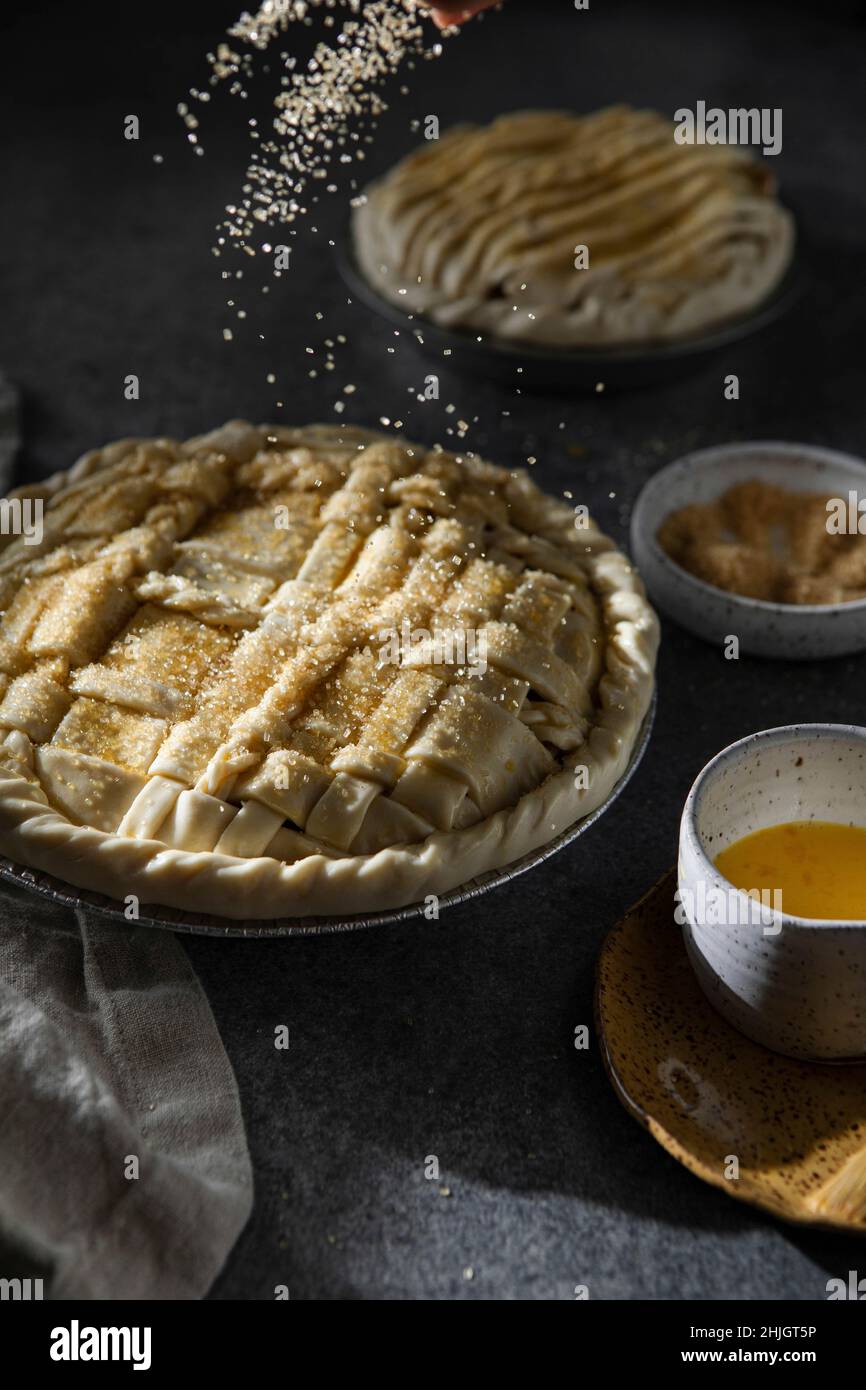 Sprinkling sugar on apple pie Stock Photo - Alamy
