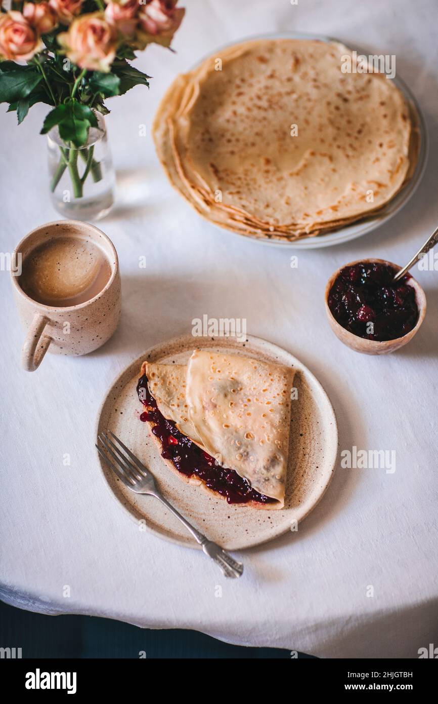 Crepes with cherry jam for breakfast Stock Photo - Alamy