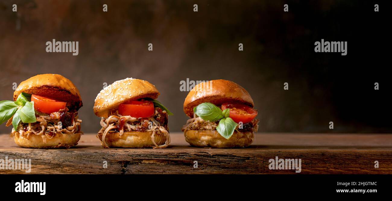 Set of homemade mini burgers in row with stew beef, tomatoes and basil ...