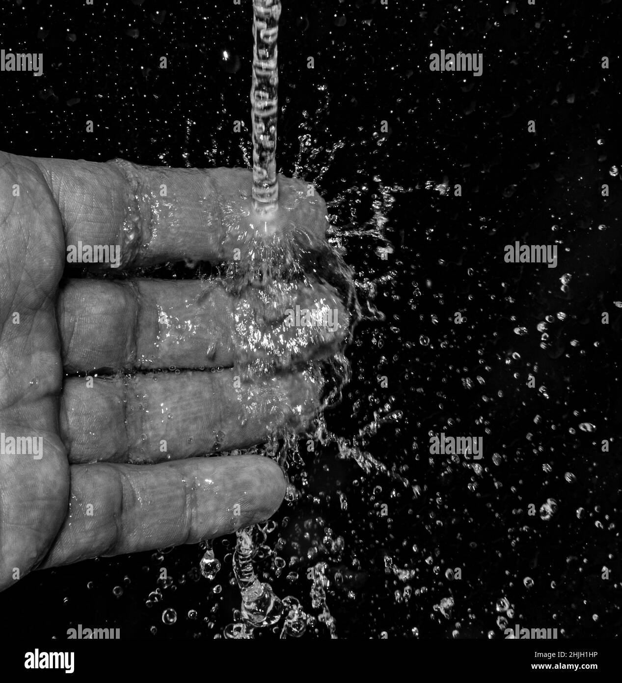 Grayscale of a hand under flowing water Stock Photo - Alamy