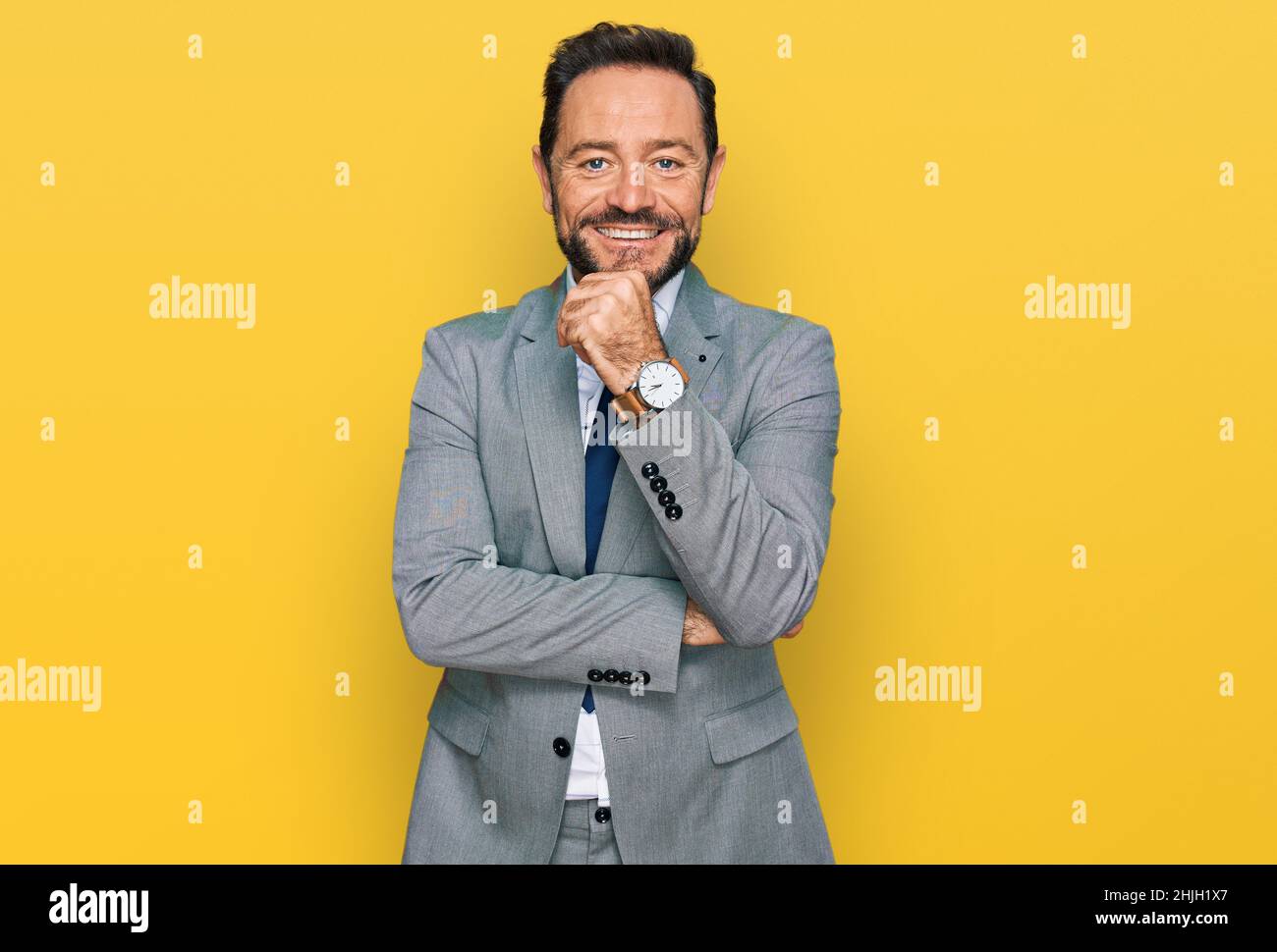 Middle age man wearing business clothes looking confident at the camera ...