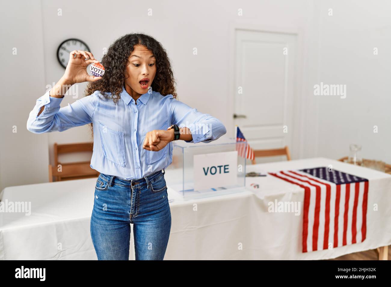 Beautiful hispanic woman standing by at political campaign by voting ...