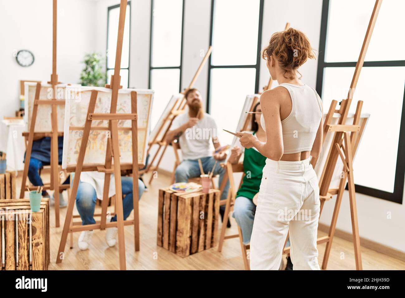 Group of people smiling happy drawing in paint class at art studio ...