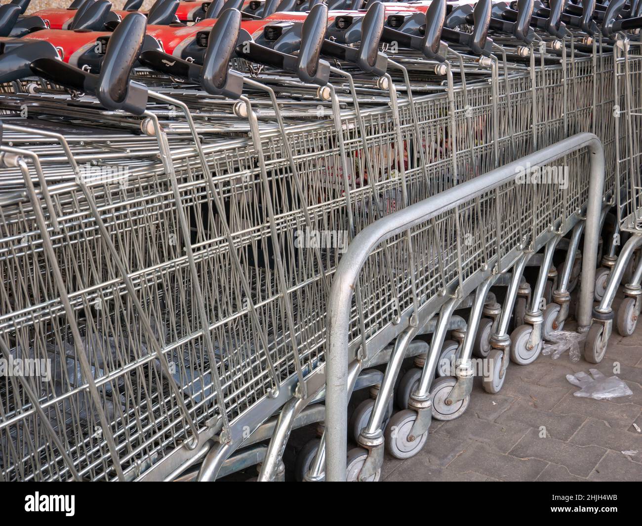 Row of stacked metal shopping trolley carts Stock Photo - Alamy