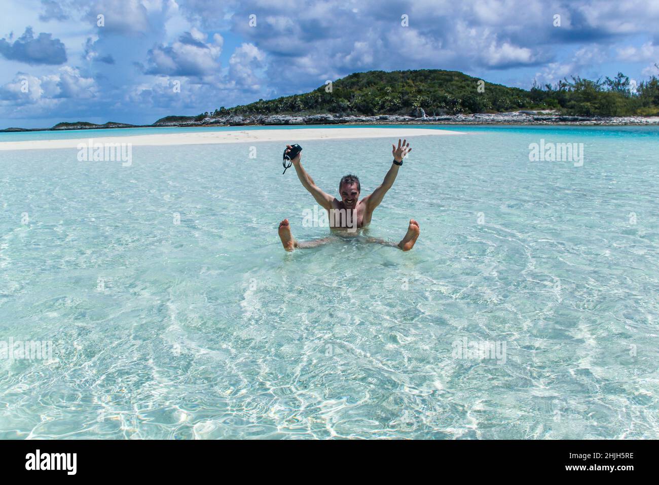 Beautiful view of man floating in Atlantic ocean on sandbar with white ...