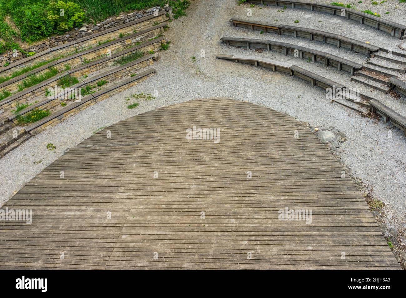 Round wooden platform and stone seats in a park in Rothenburg ob der ...