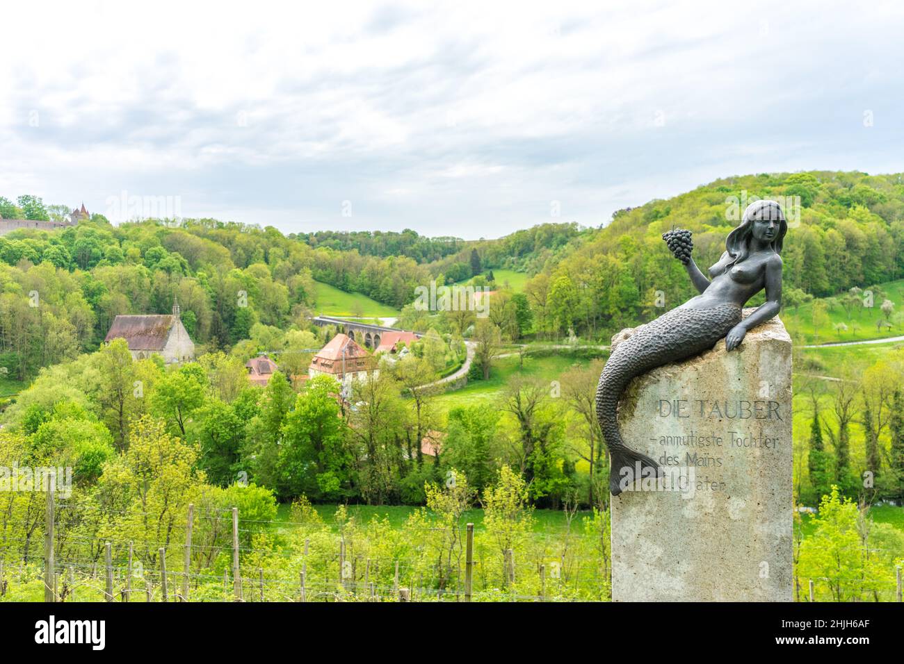 Historic mermaid statue overlooking rural forests in Rothenburg ob der ...