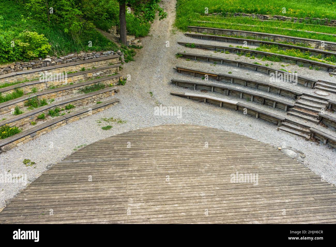 Round wooden platform and stone seats in a park in Rothenburg ob der ...