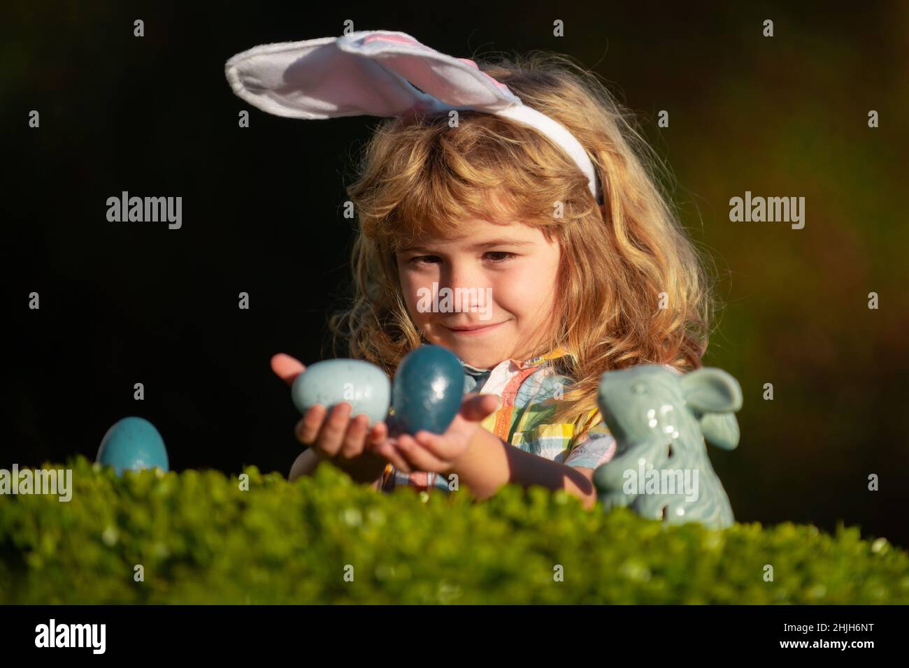 Children hunting easter eggs. Excited kid boy finding easter eggs ...