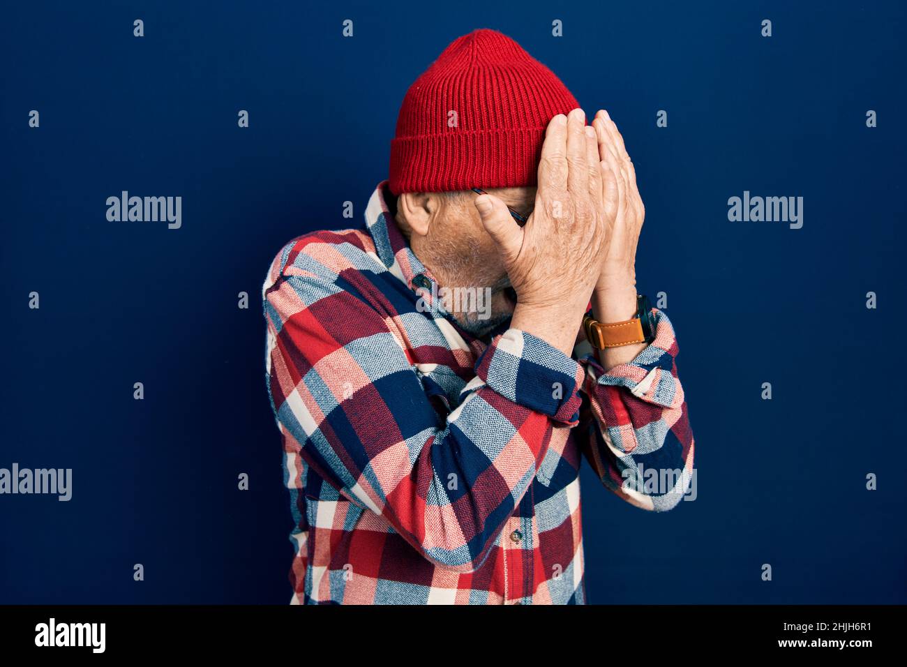 Handsome mature man wearing hipster look with wool cap with sad ...