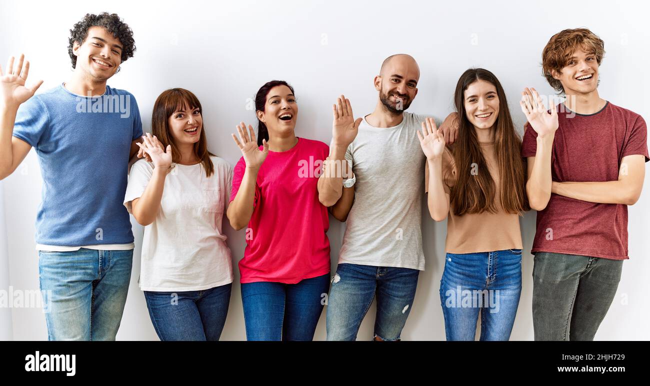 Group of young friends standing together over isolated background ...