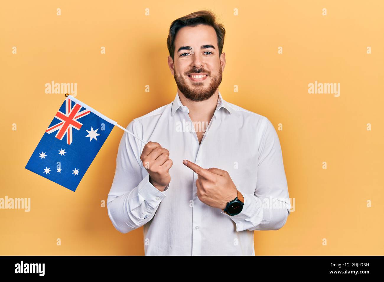 Handsome caucasian man with beard holding austria flag smiling happy ...