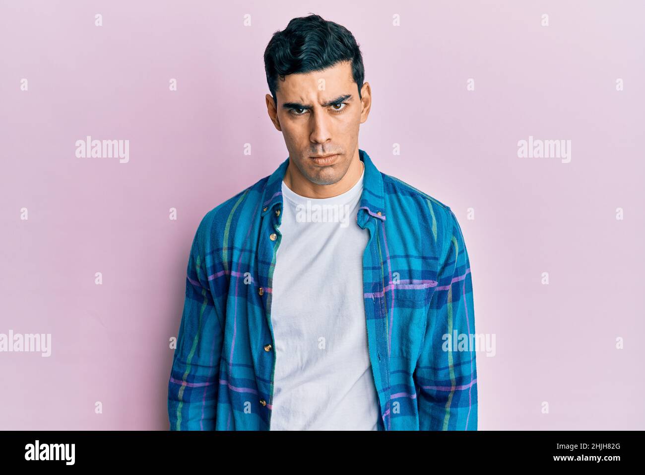Handsome hispanic man wearing casual clothes skeptic and nervous ...