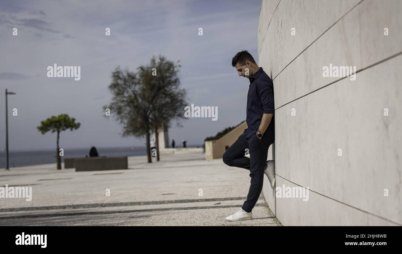 A stylish freelance architect relaxing alone near the urban concept ...