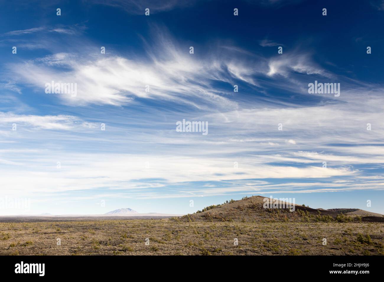 High cirrus clouds wisping above cinder cones beyond the Broken Top ...