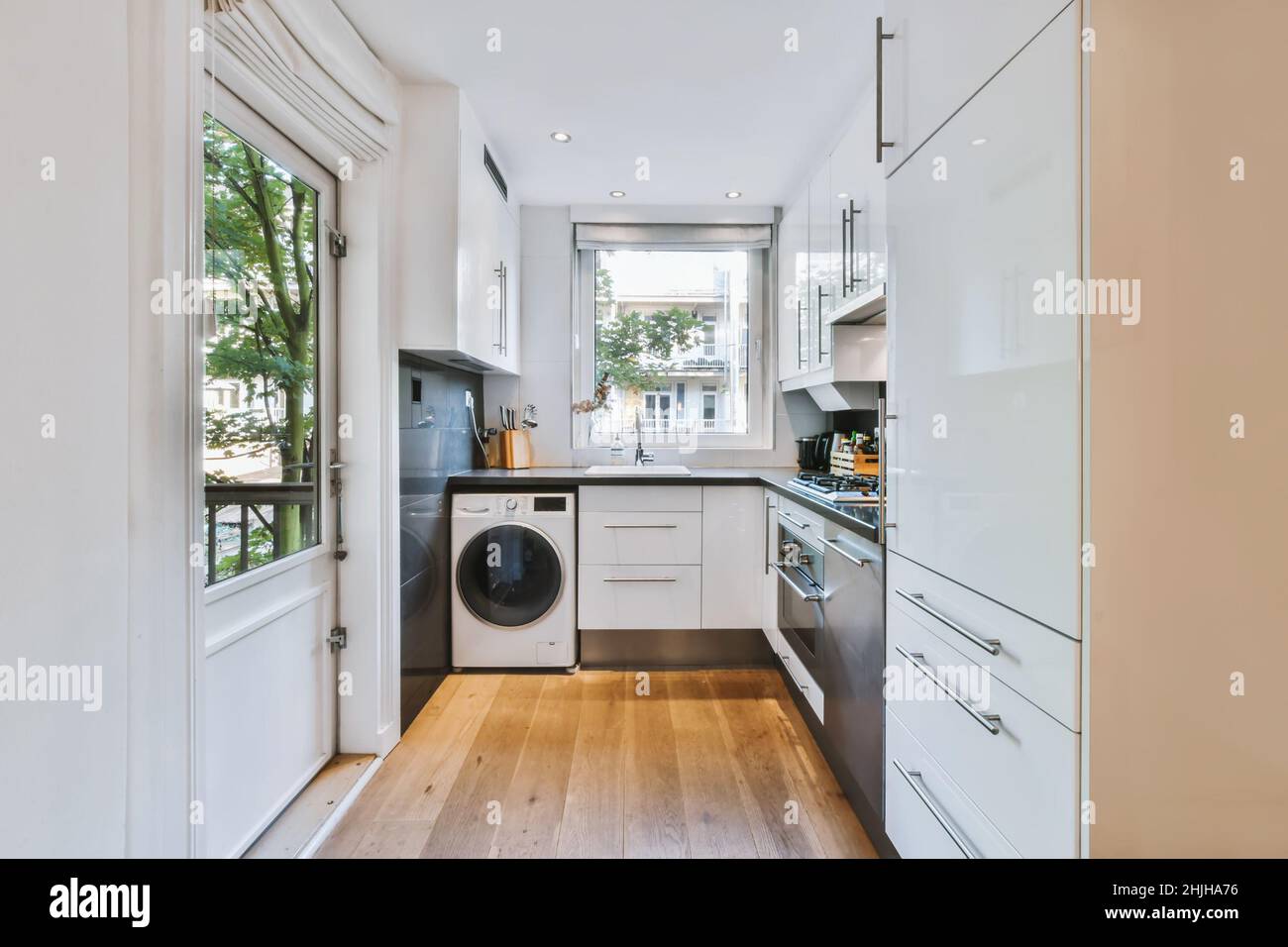 Spectacular kitchen with black countertop and washing machine Stock ...