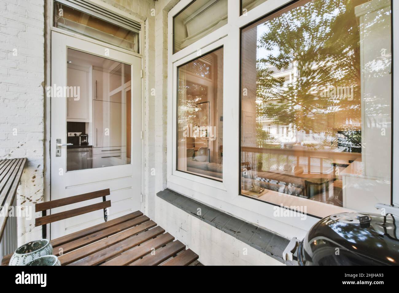 Spectacular little balcony with wooden table and chair Stock Photo - Alamy