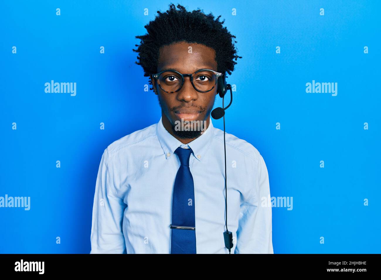 Young african american man wearing call center agent headset thinking ...