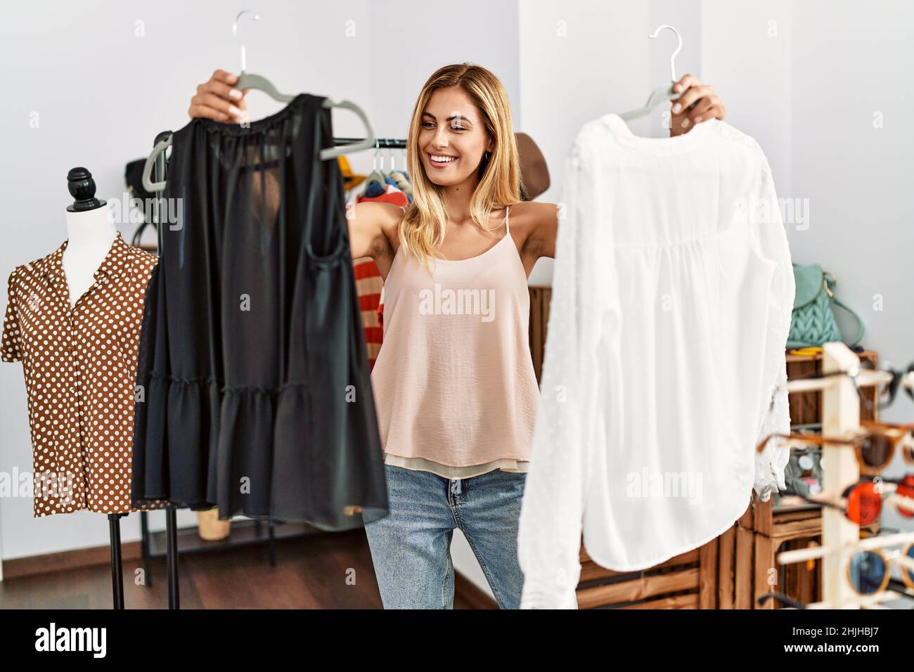 Young caucasian customer woman smiling happy chossing clothes at ...