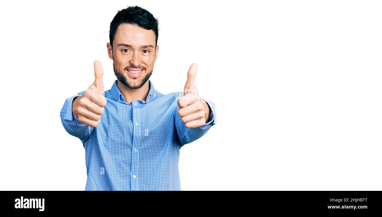 Hispanic man with beard wearing casual business shirt approving doing ...