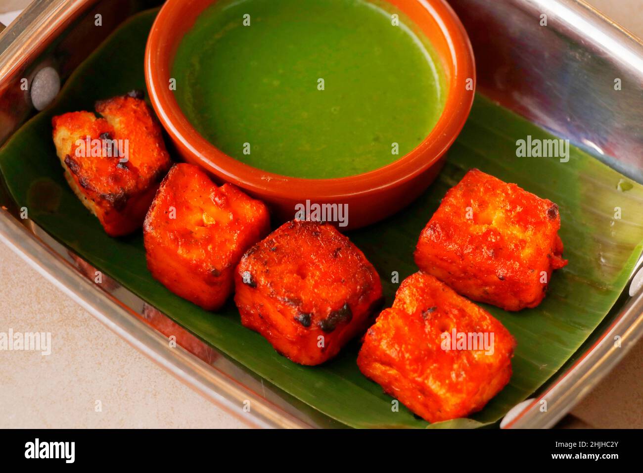 tandoori paneer tikka ( cottage cheese ) indian style snack or bar bite food served with green ...