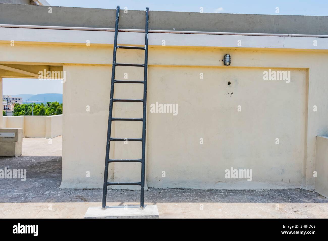 front view of stair case placed on top of the terrace in a day time ...