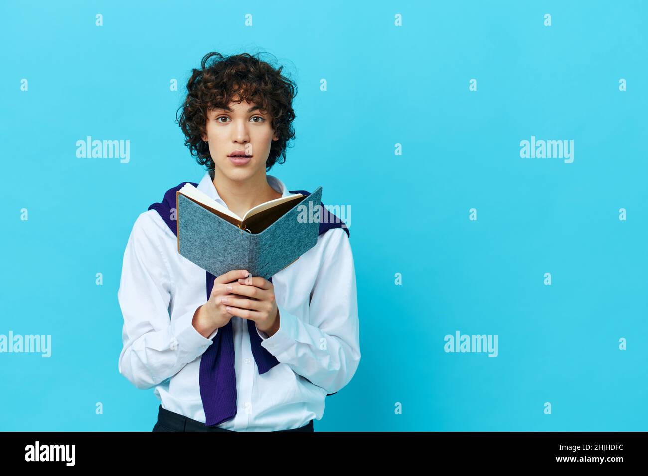 curly guy with a notepad in a sweater shirt on the shoulders isolated ...