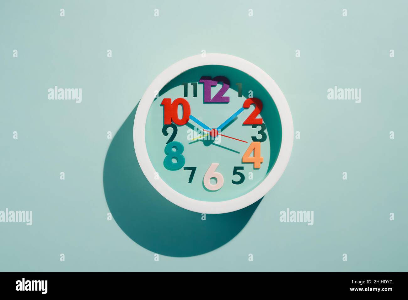 Photos of round children's wall clocks with multi-colored numbers on ...