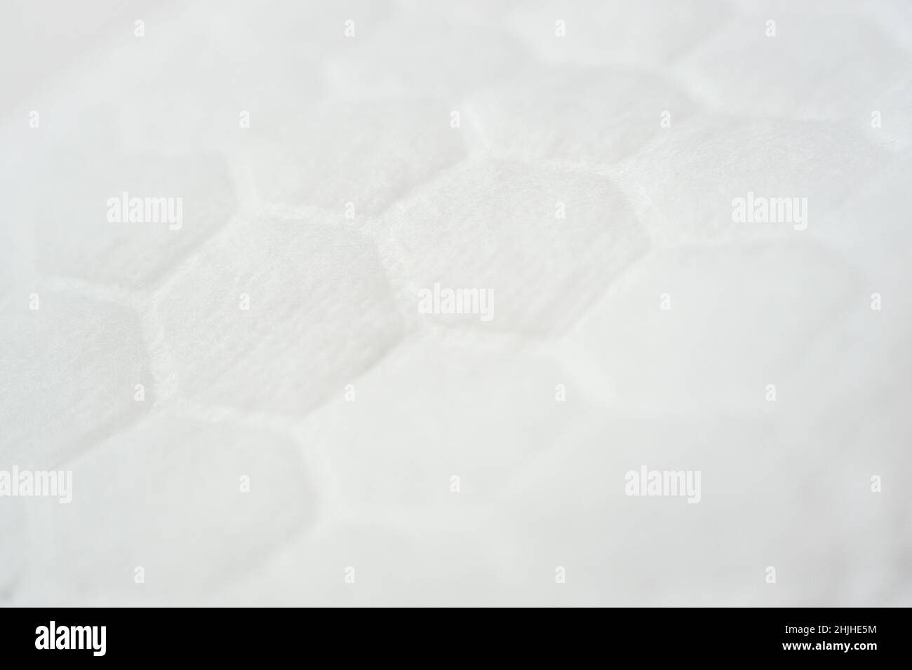 This is blank white fabric background with texture of honeycombs or ...