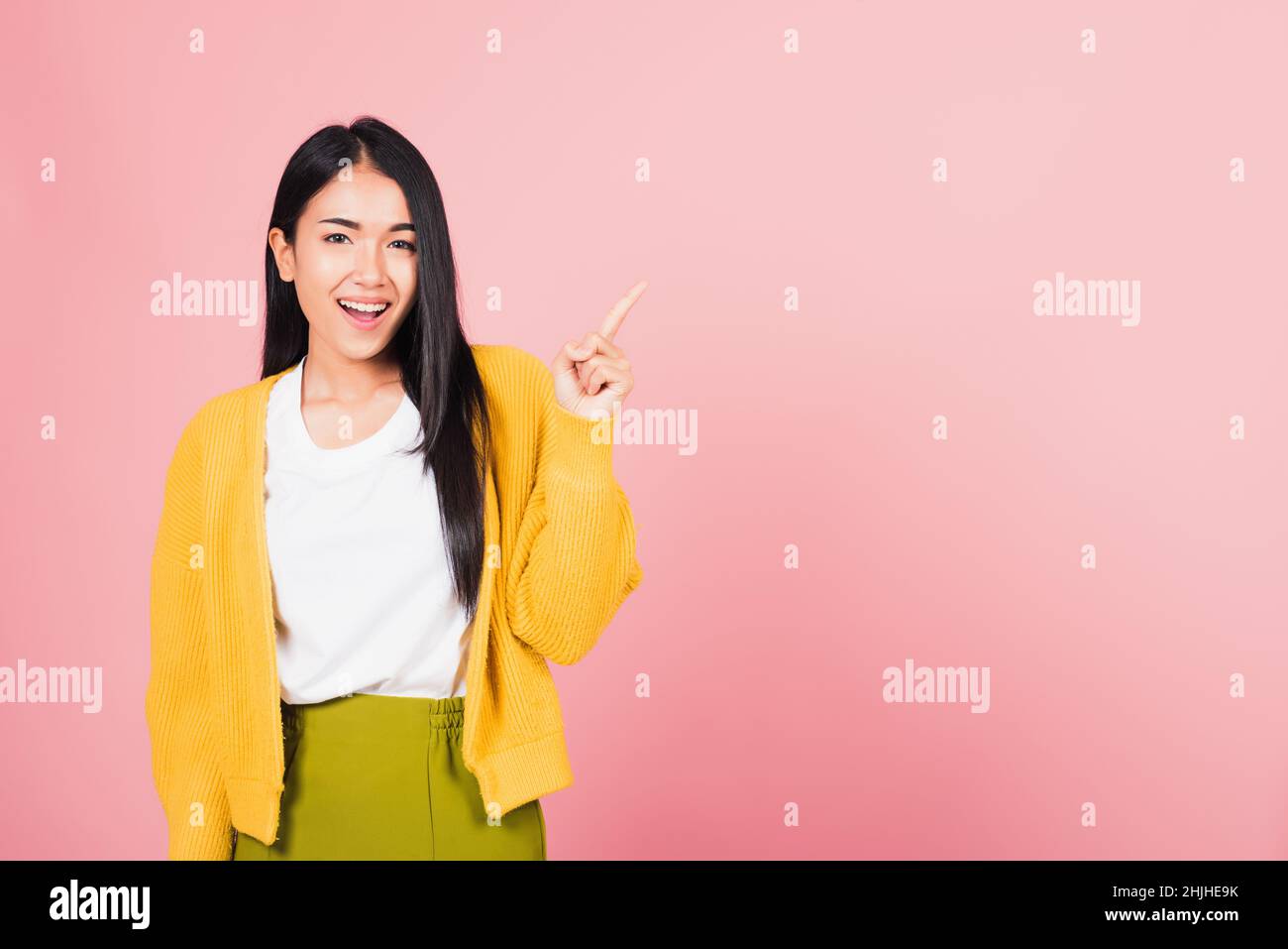 Portrait Asian beautiful young woman smiling standing pointing finger ...