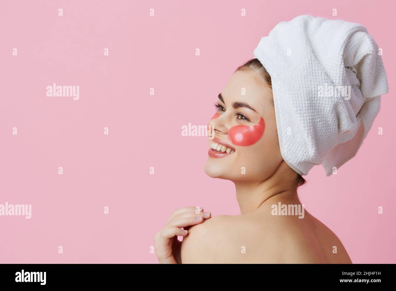 beautiful woman pink patches on the face with a towel on the head pink ...