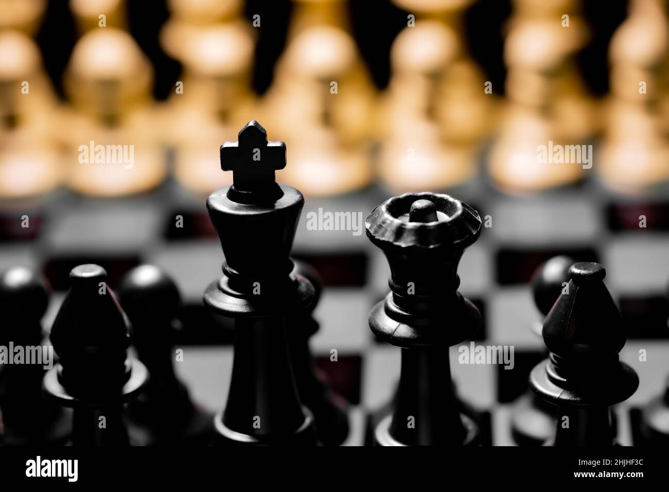 Close up of Chess pieces on a reflective mirror board surface with a ...