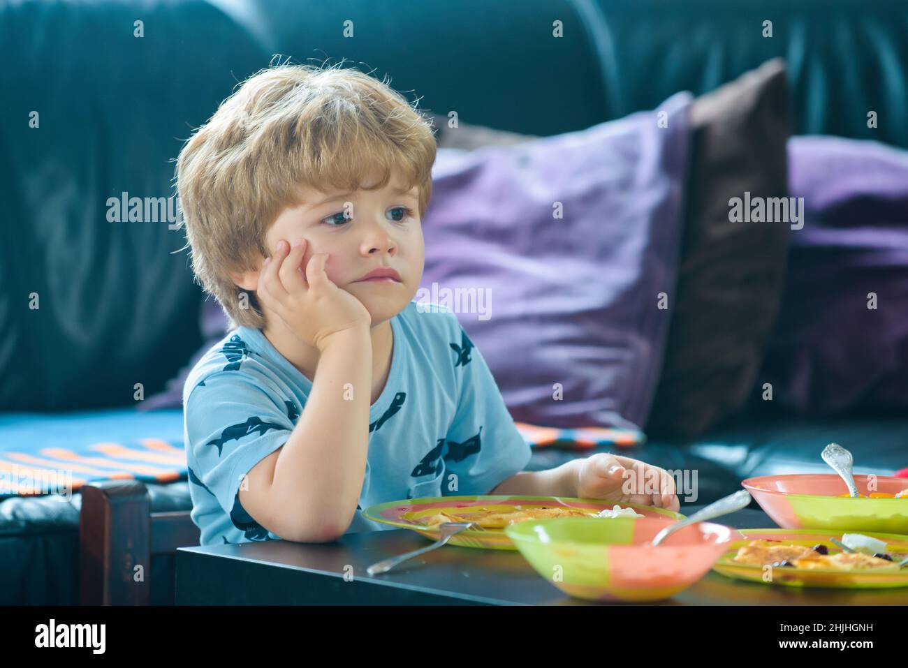Baby child eating food. Kid boy eating healthy food Stock Photo - Alamy