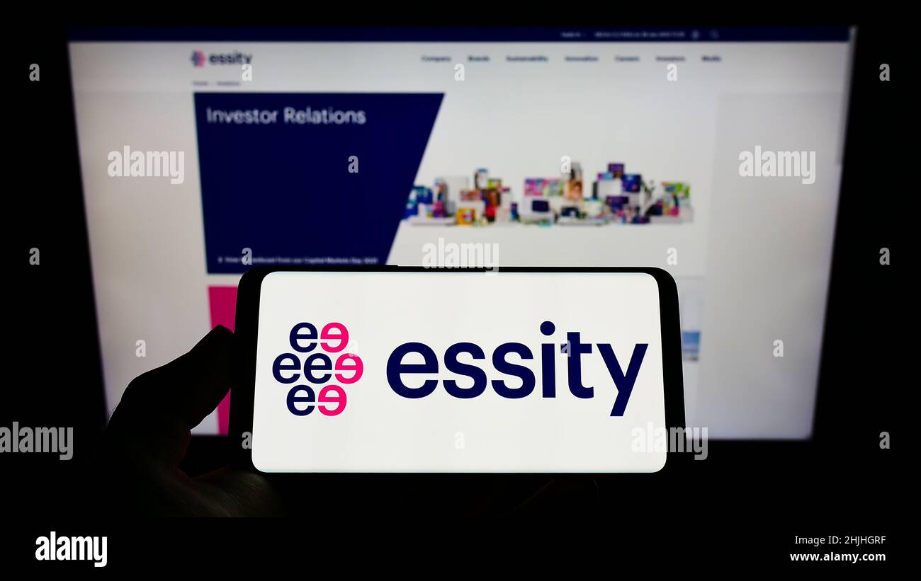 Person holding smartphone with logo of Swedish consumer goods company ...