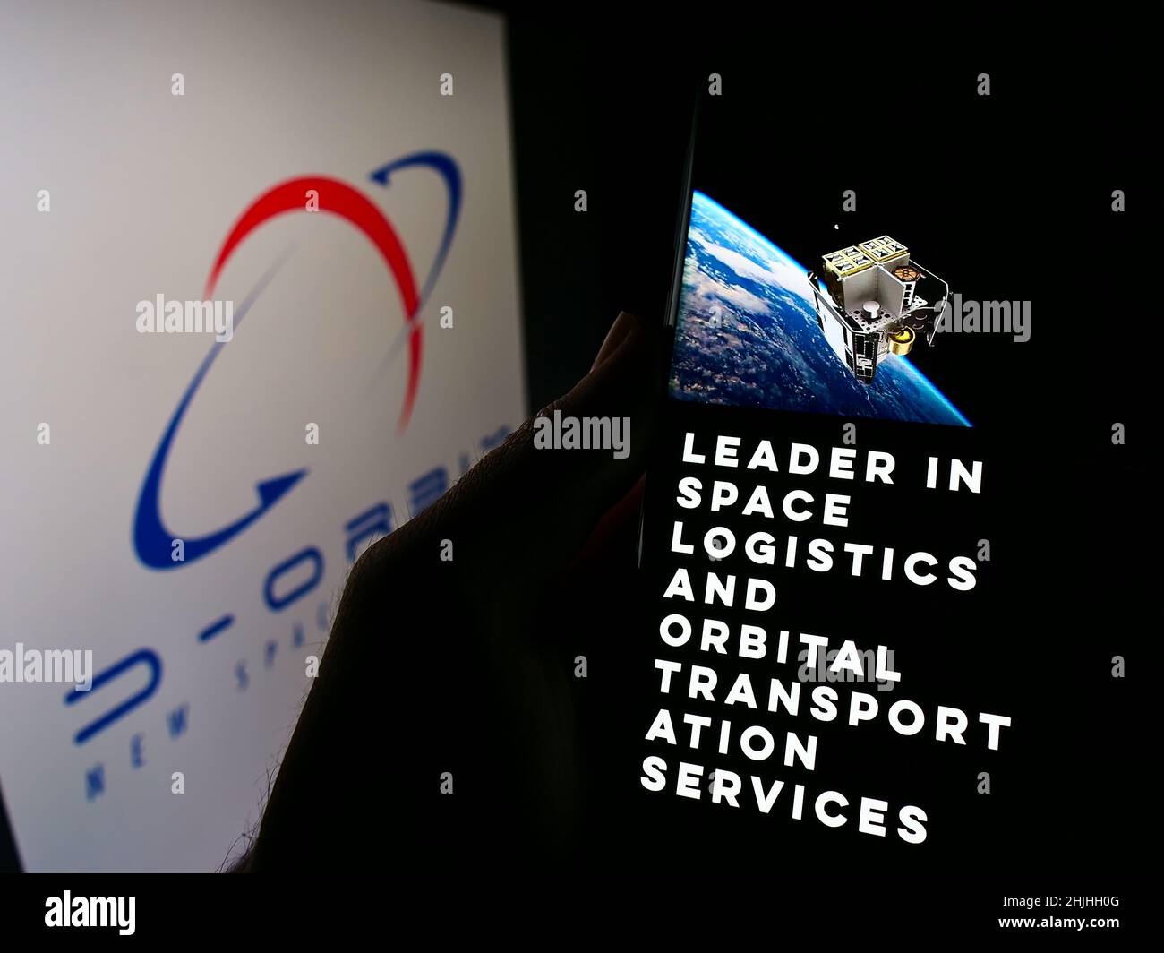 Person holding mobile phone with webpage of Italian aerospace company D ...